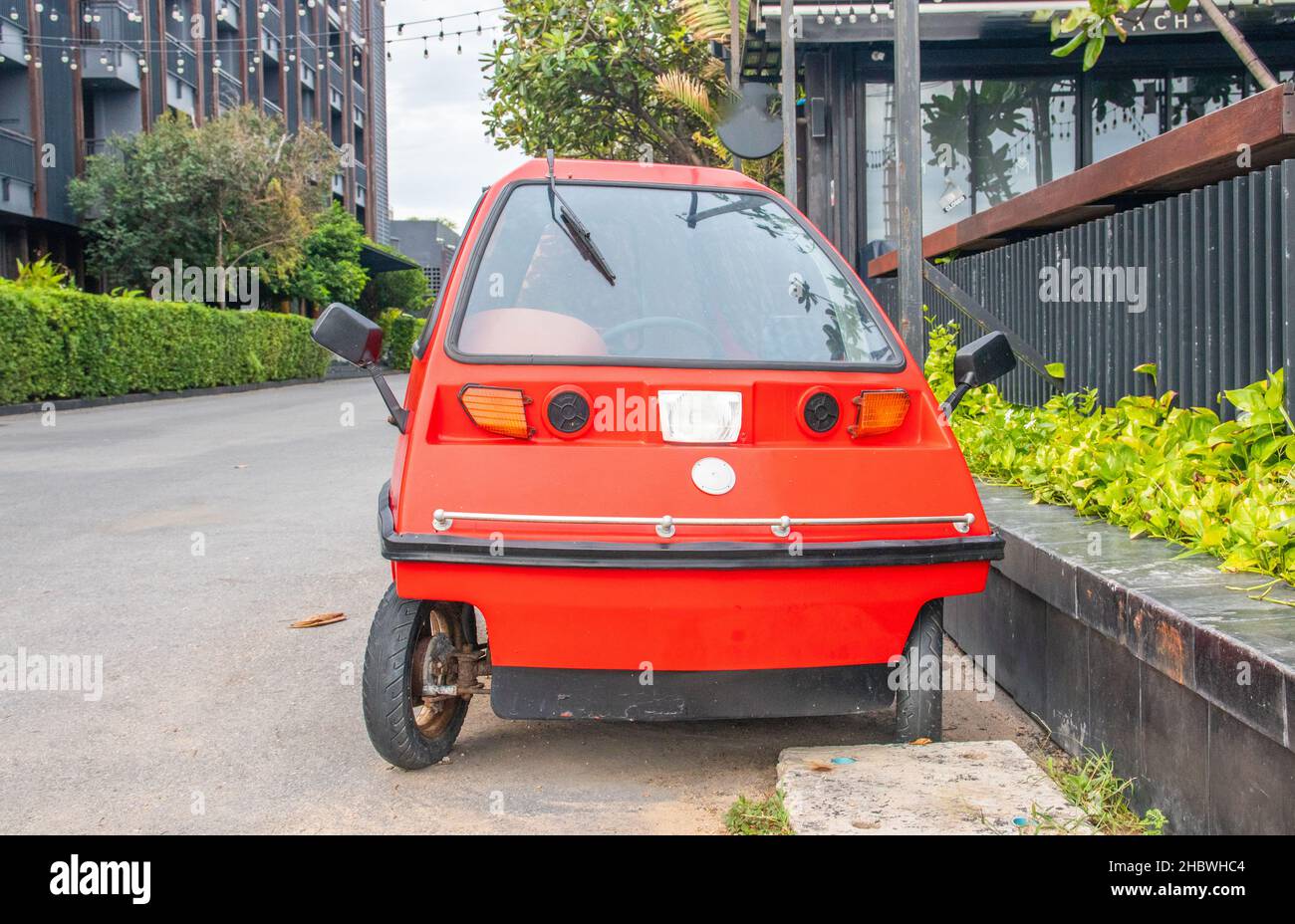 A red tuk tuk vehicle parked in the street Stock Photo - Alamy