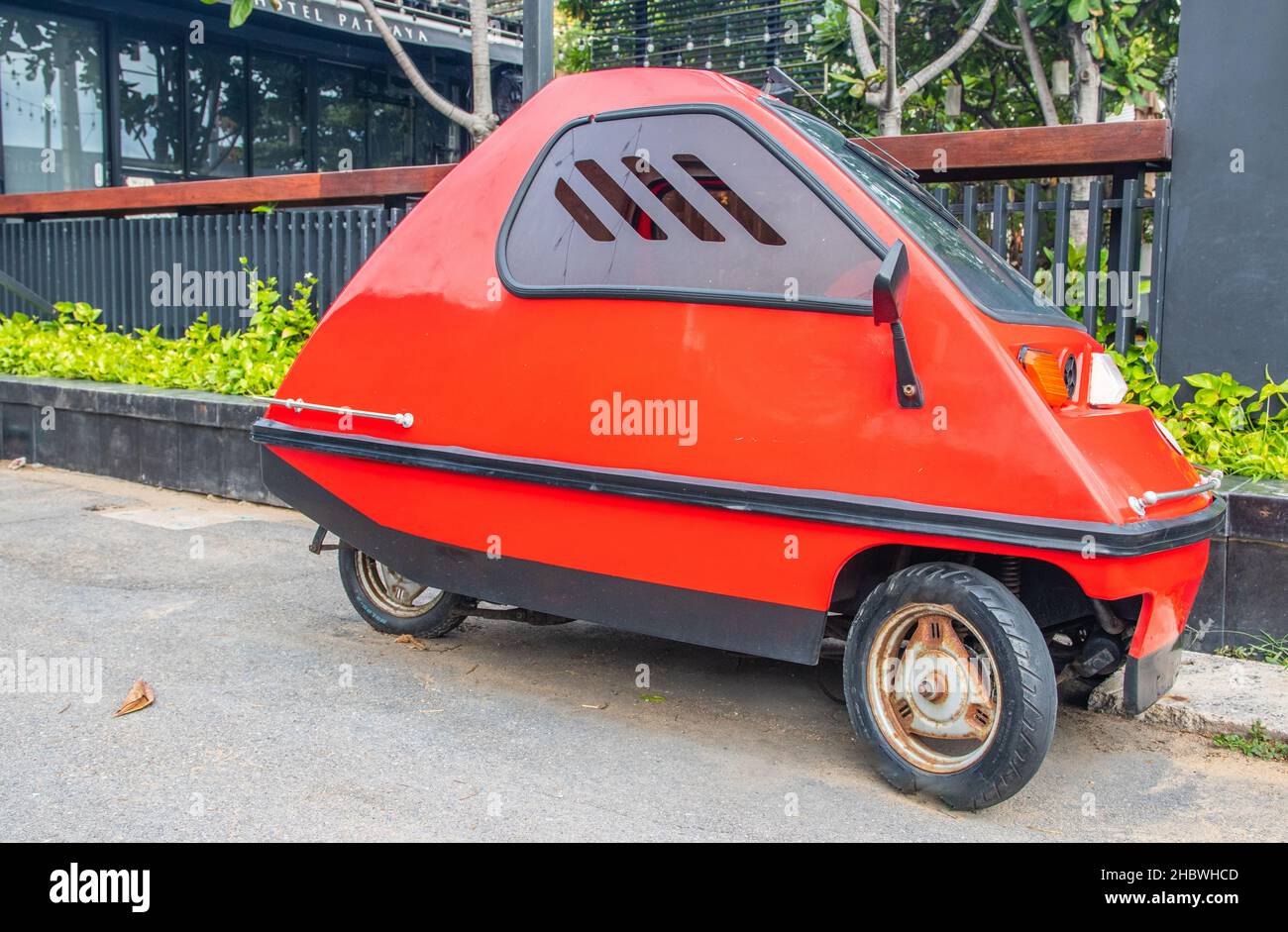 A red tuk tuk vehicle parked in the street Stock Photo - Alamy