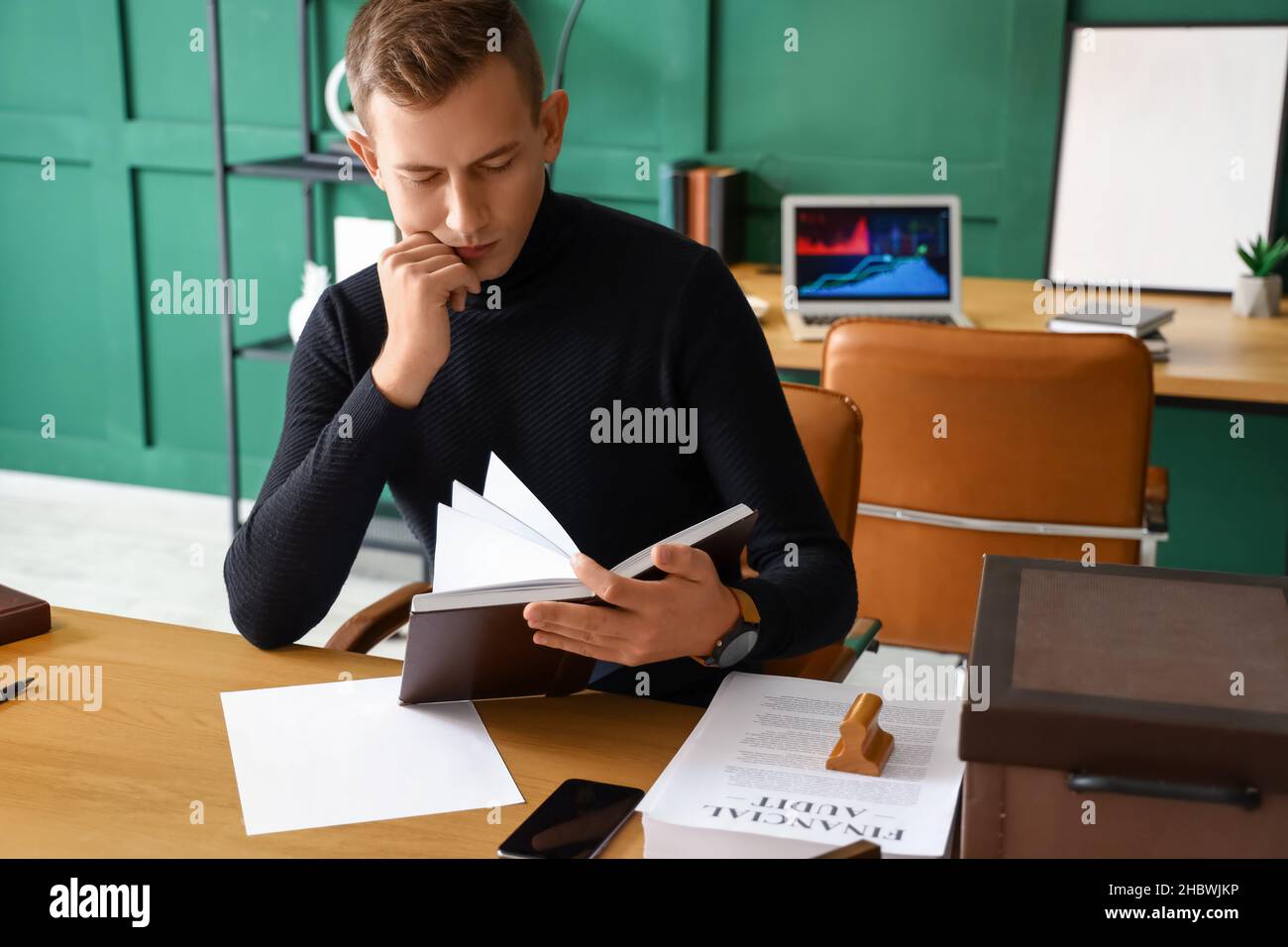 Young male notary public working in office Stock Photo - Alamy