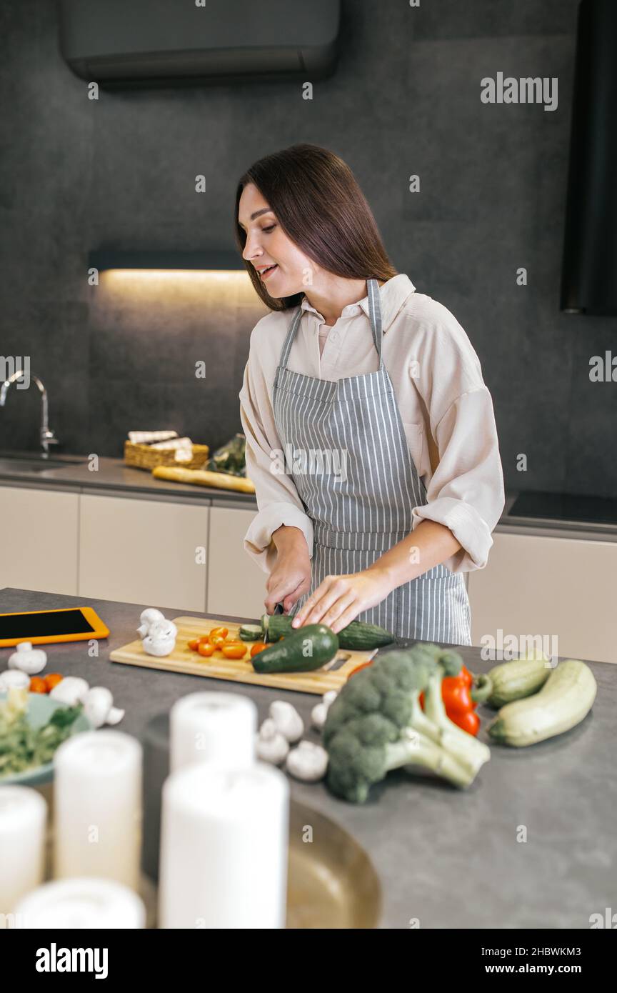 Long-haired young housewife cooking in the kitchen Stock Photo - Alamy