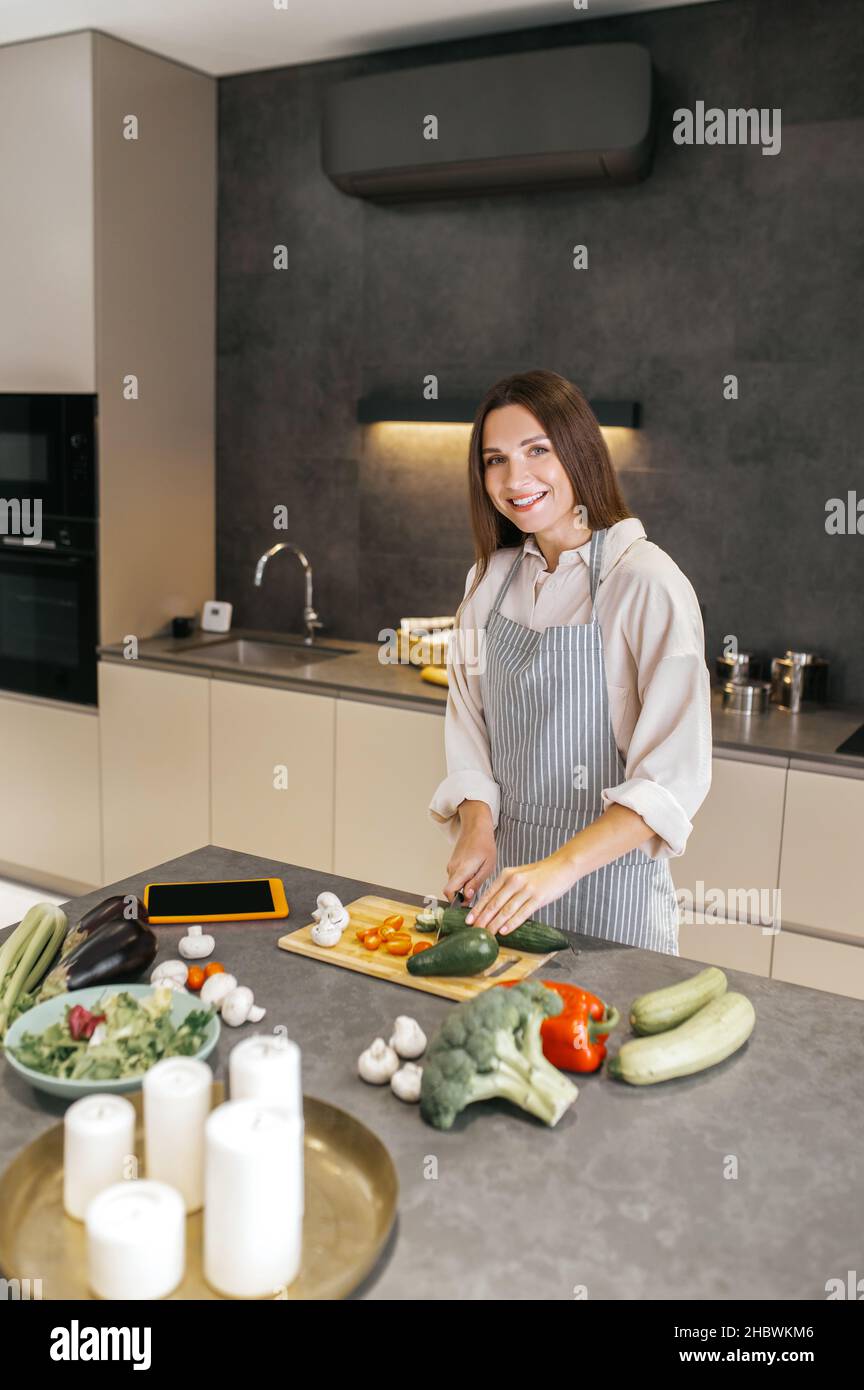 Long-haired young housewife cooking in the kitchen Stock Photo - Alamy
