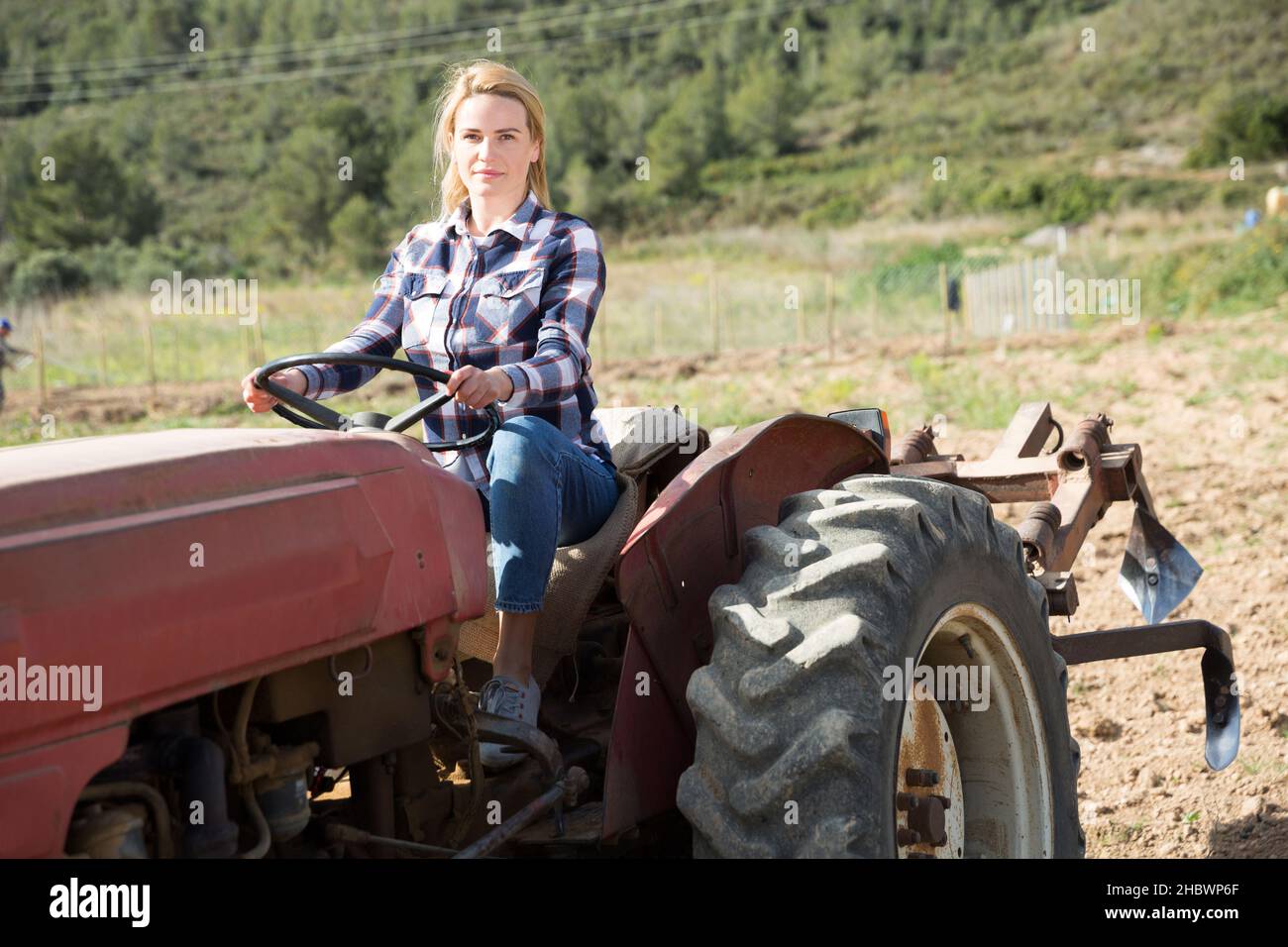 Female farmer working on farm tractor Stock Photo - Alamy