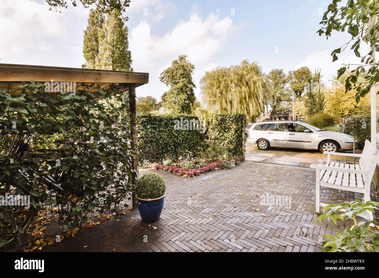 Lovely courtyard with greenery and a parked car Stock Photo - Alamy