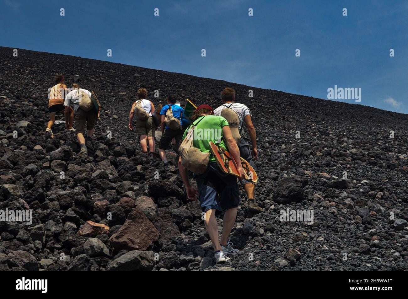 Foreign tourists climb the slopes of the Cerro Negro volcano to ...