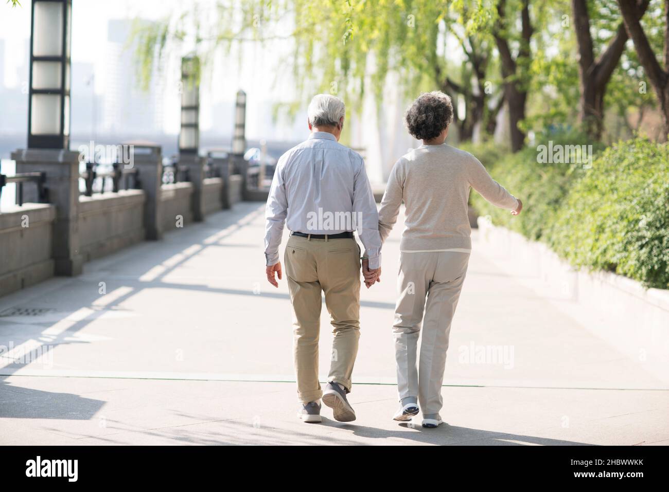Happy old couple walking in the park Stock Photo - Alamy