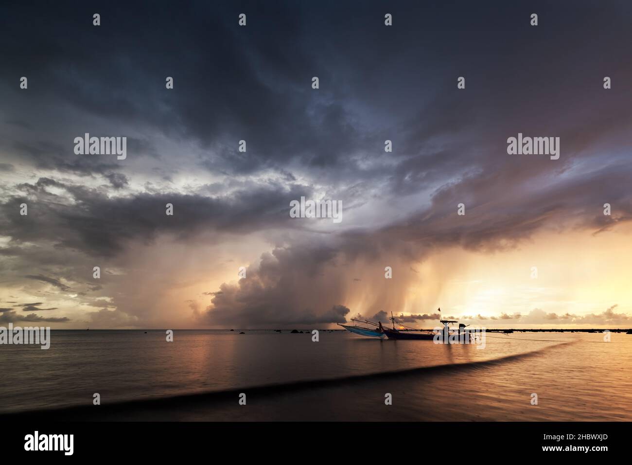 beautiful sunset and rain storm with Opossum shrimp boats moored at the ...