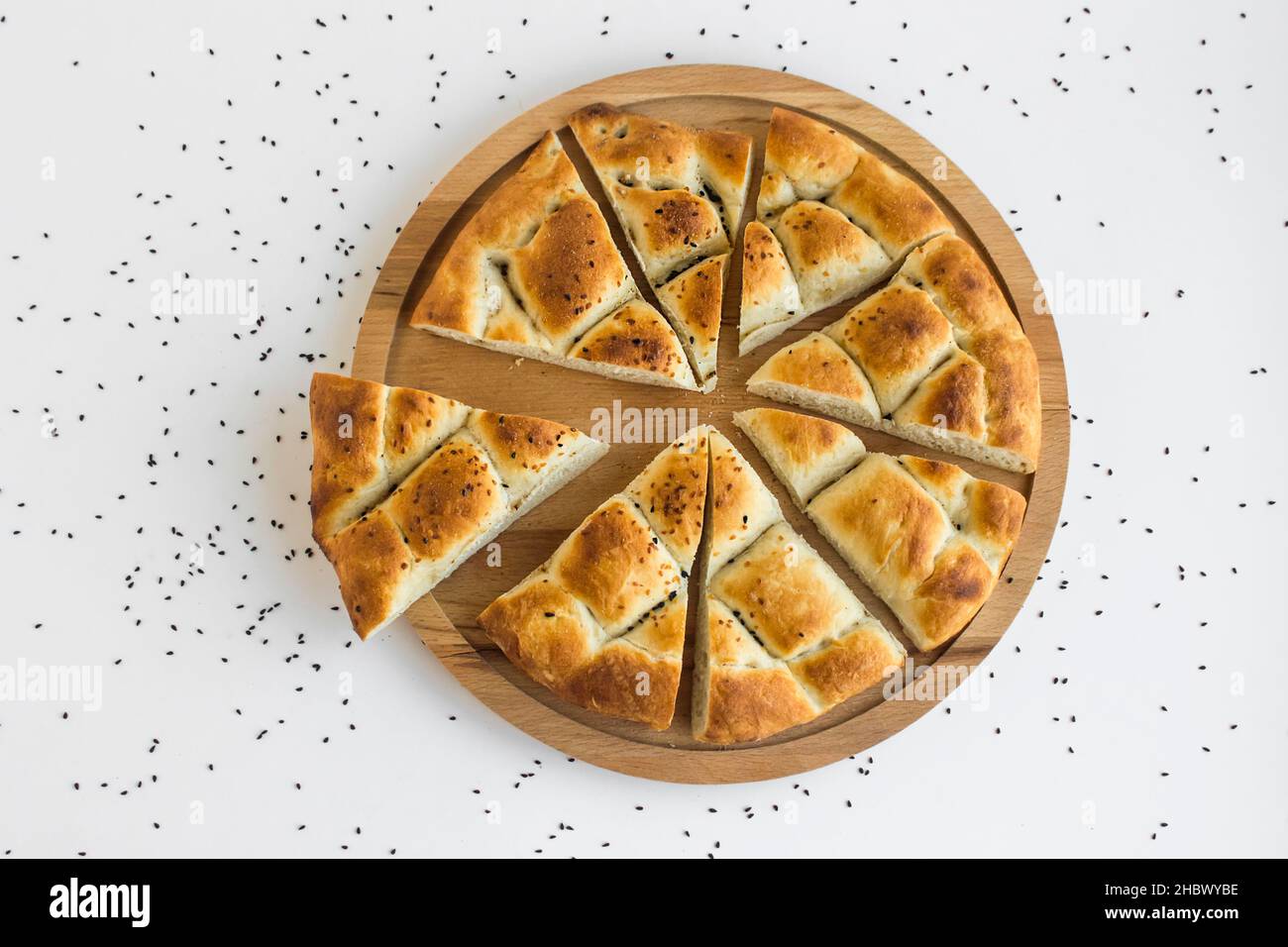 Triangle sliced ramadan bread,pide on the wooden plate with sesame and ...
