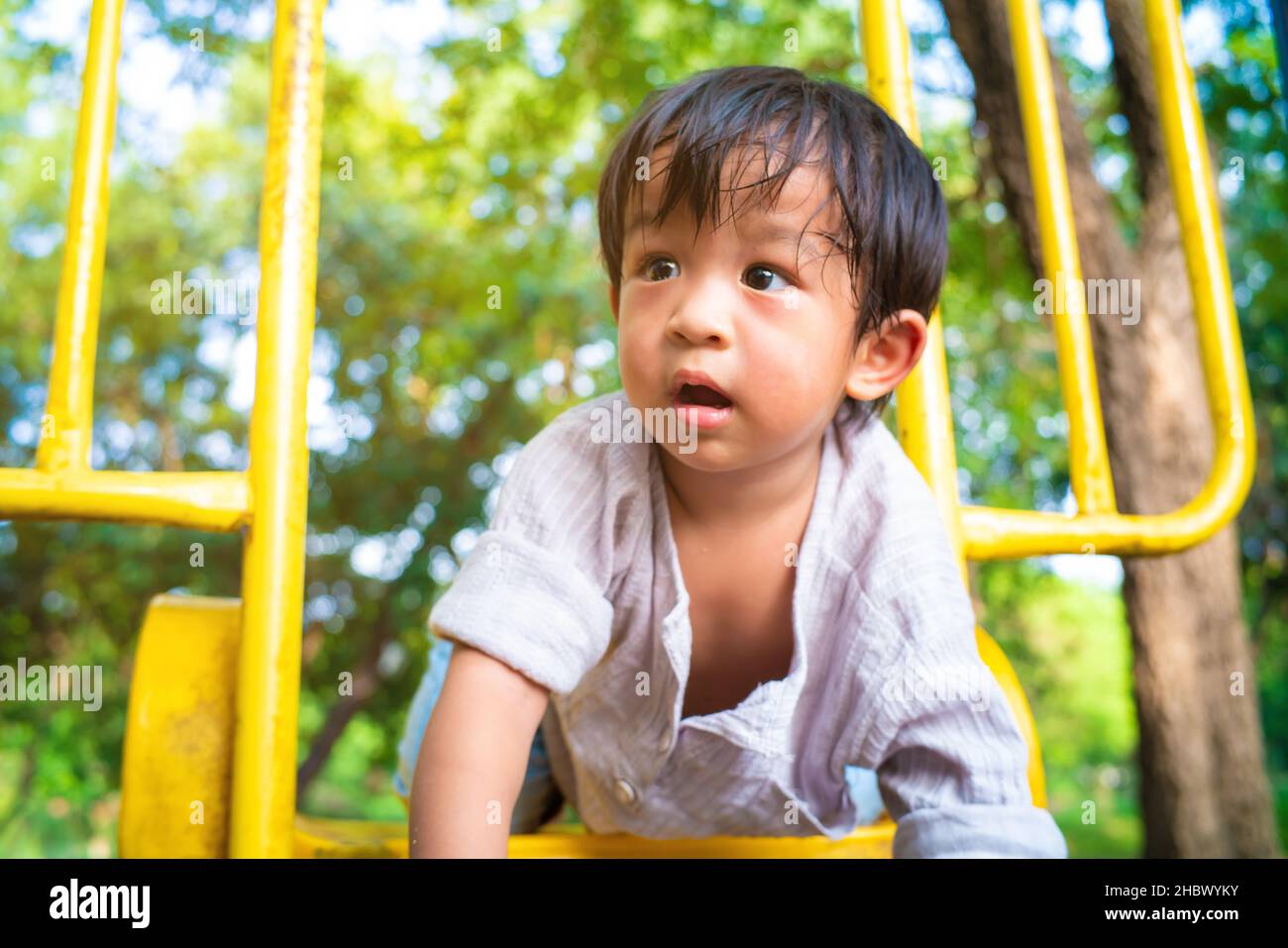 Toddler preschool boy playing slider outdoor park smiling kid in ...