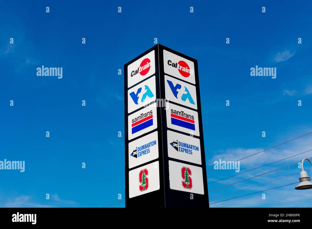 Signpost with names of public transportation transit services ...
