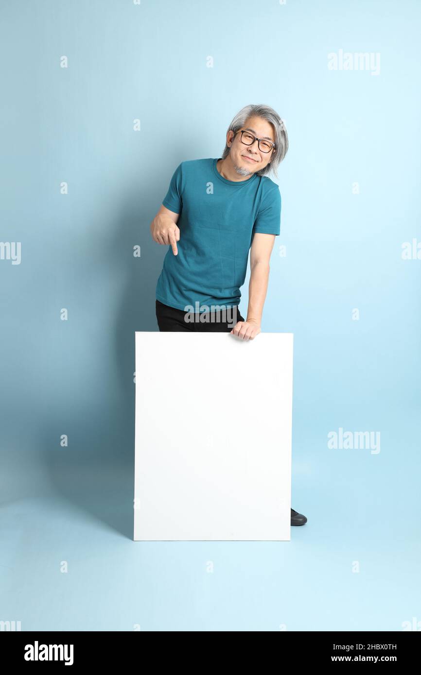 The senior Asian man on the blue background Stock Photo - Alamy
