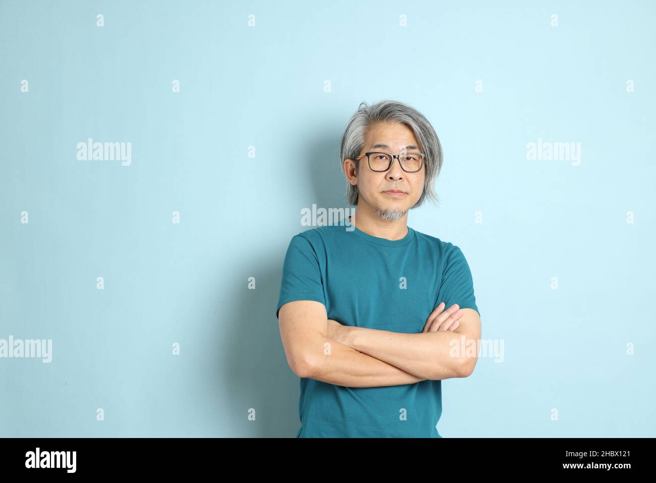The senior Asian man on the blue background Stock Photo - Alamy