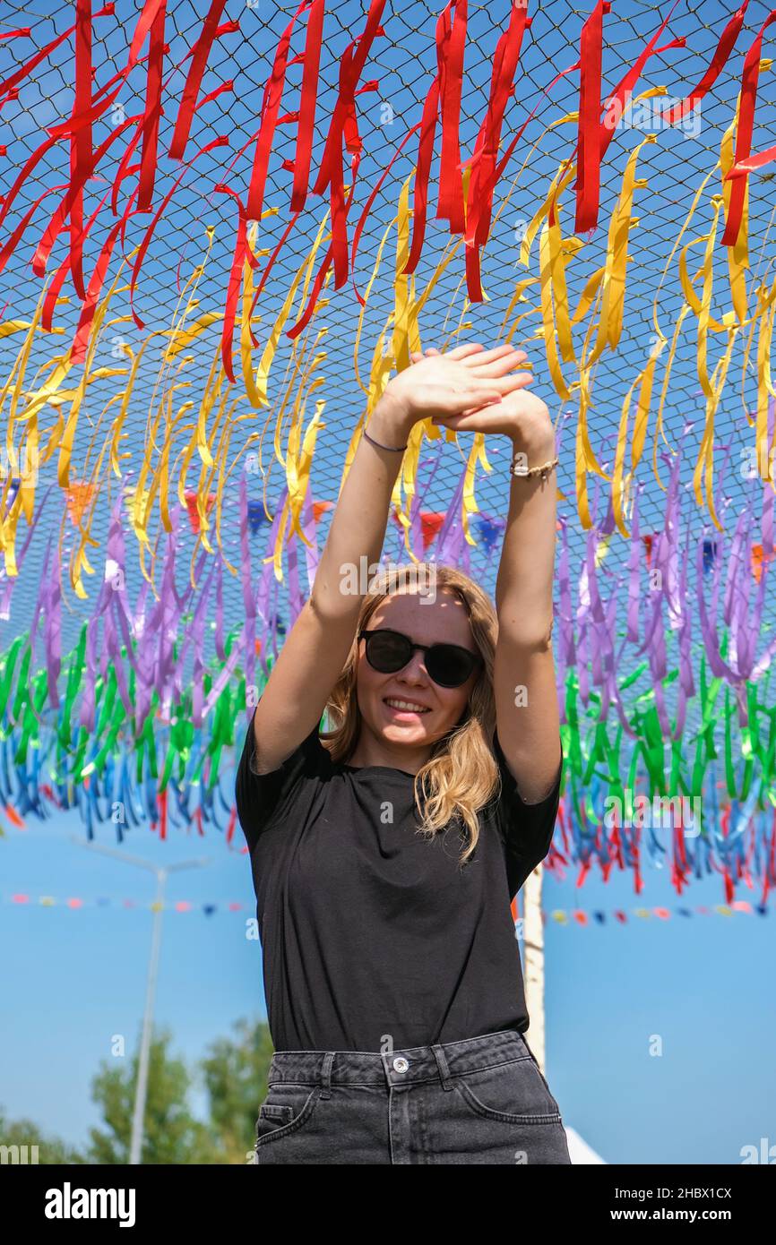 Young woman sitting on festival. Gen z girl enjoying outdoors ...