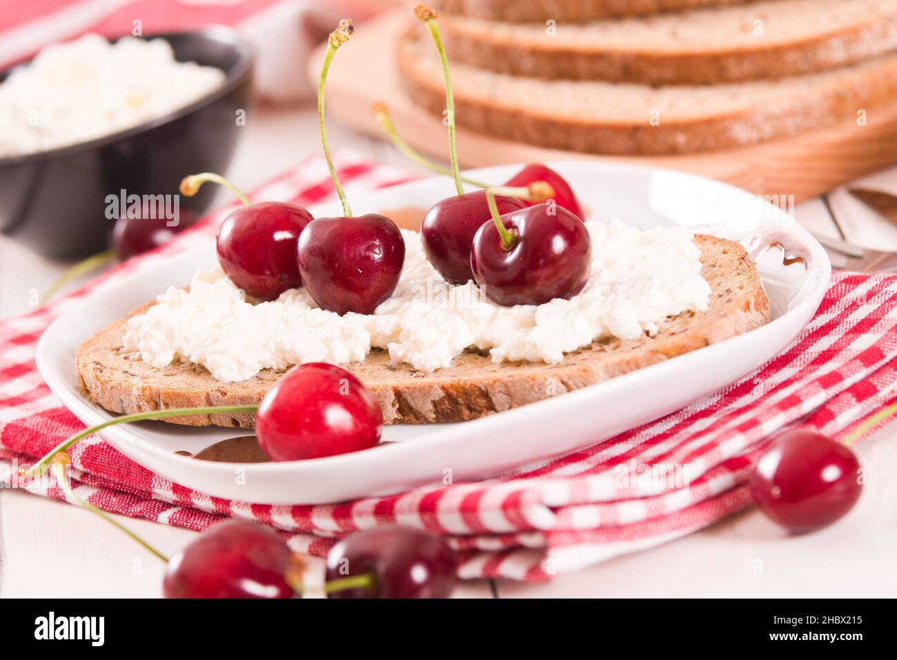 Rye bread with cottage cheese and cherries Stock Photo - Alamy