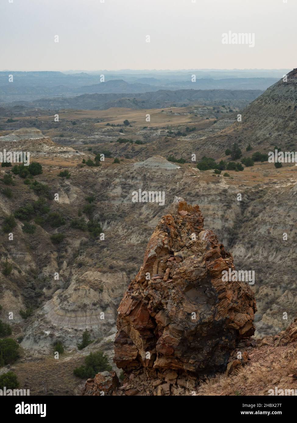Orange rock formation at the edge of the overlook at Terry Badlands in ...