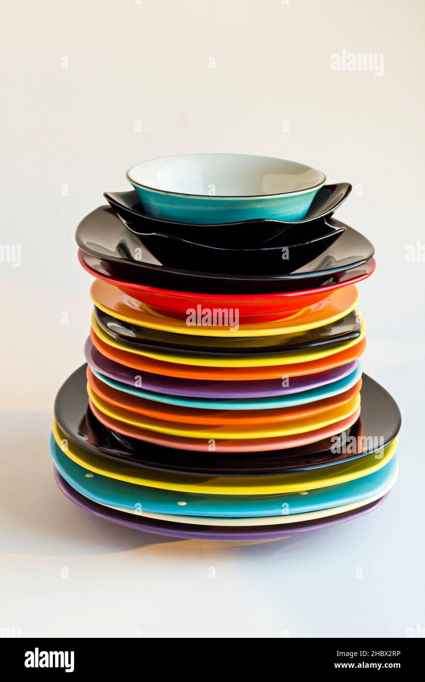 Colorful,clean dinner plates stacked on white surface.Close up taken ...