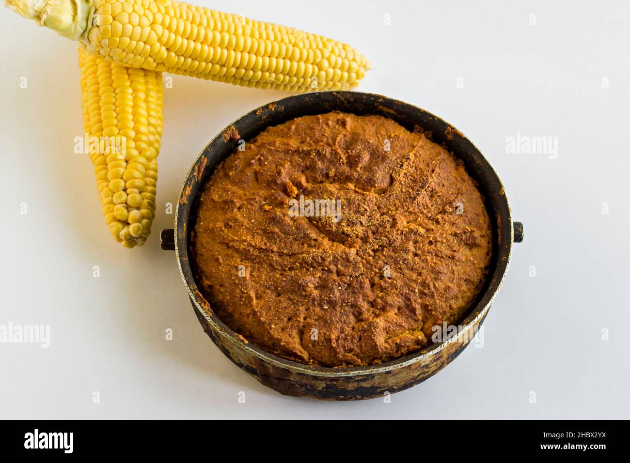 Crispy,Natural Cornbread in metal ovenware with two corncobs on the ...