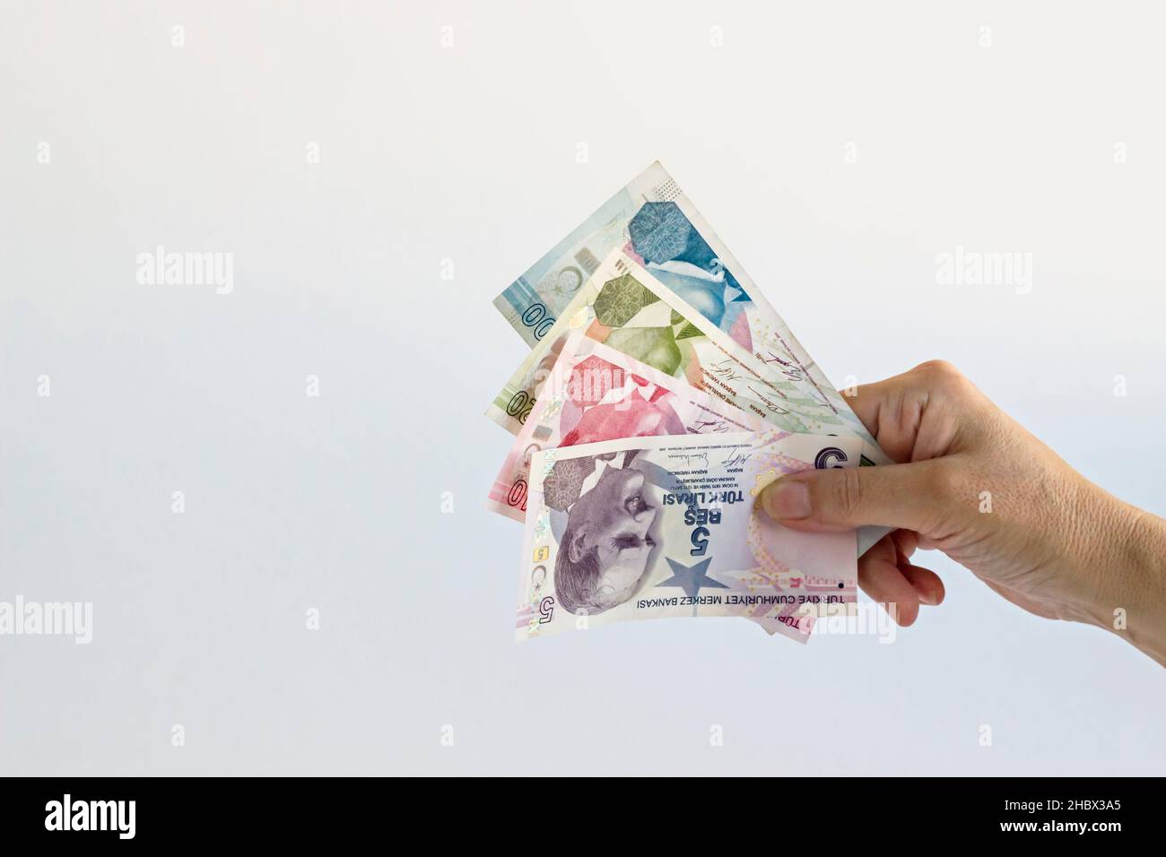 Hand holding Turkish Money,banknotes on white background with copy ...