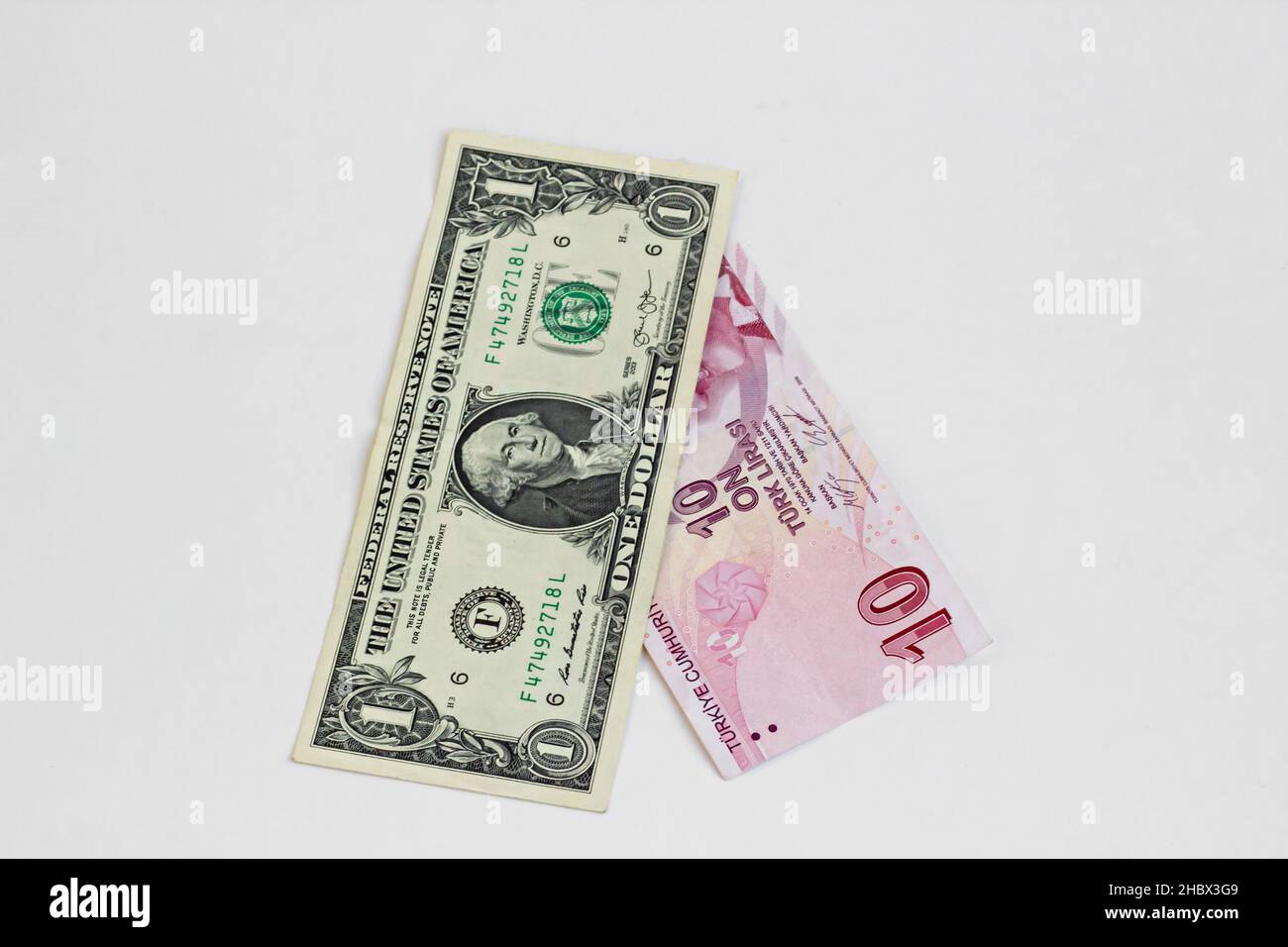 Ten Lira Banknote Of Turkish Money on the white surface with one dollar ...