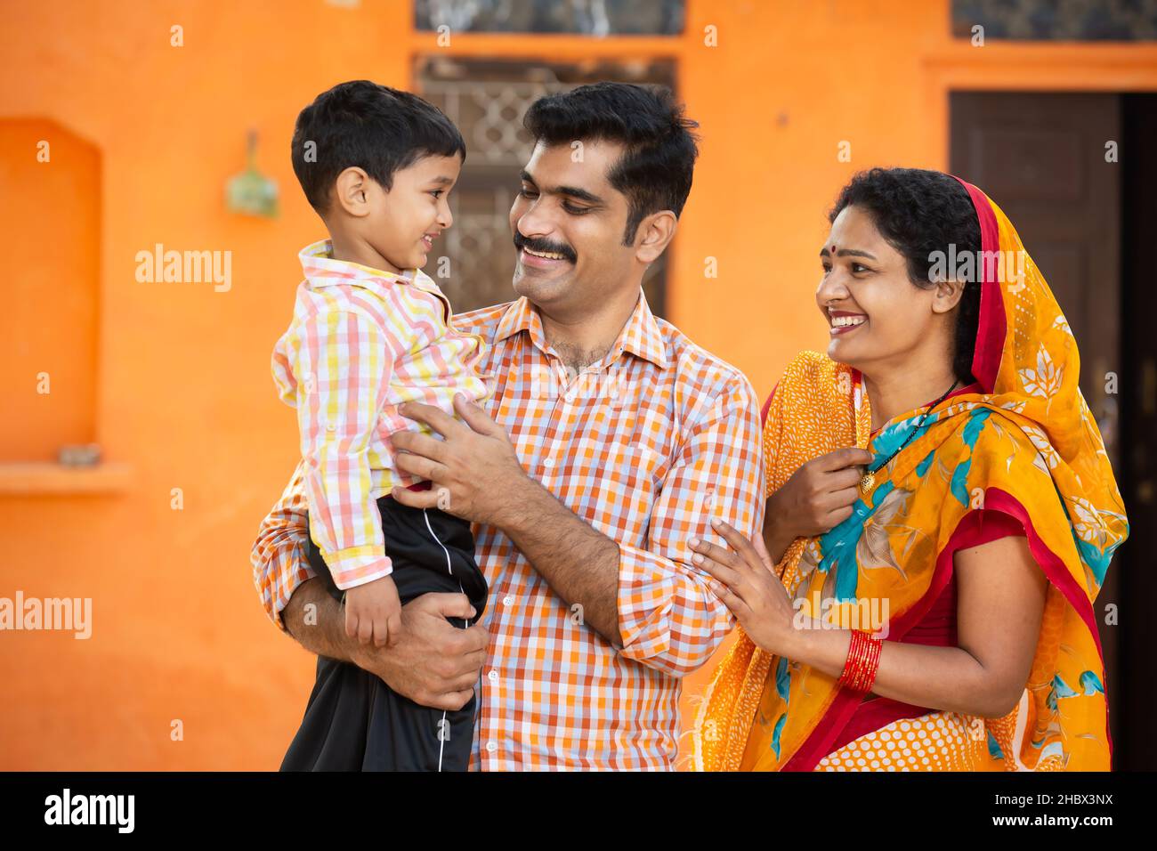 Young happy indian parents holding cute little child having fun and ...