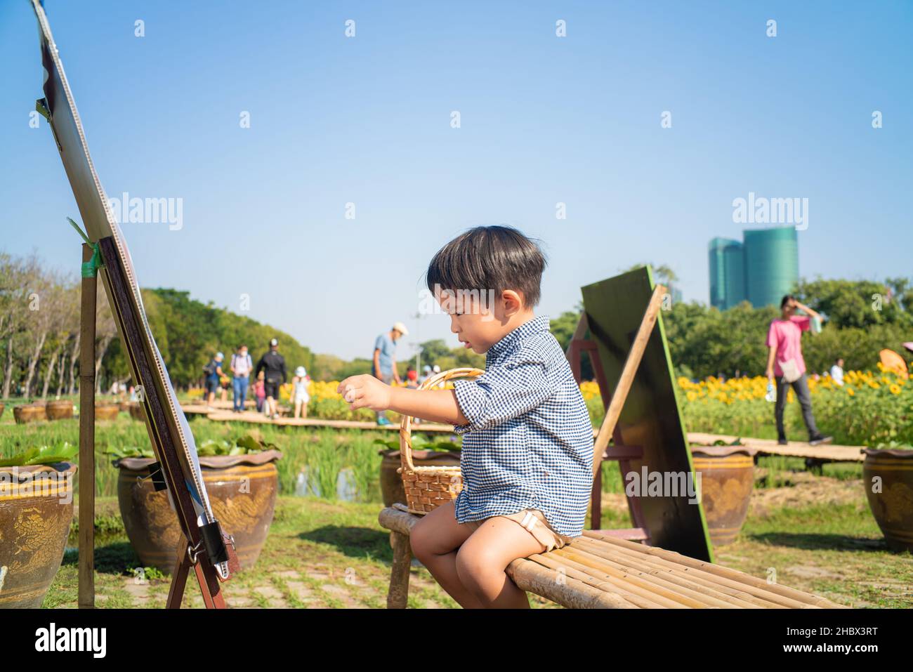 Asian kid boy drawing paint on paper in flower outdoor park Stock Photo ...