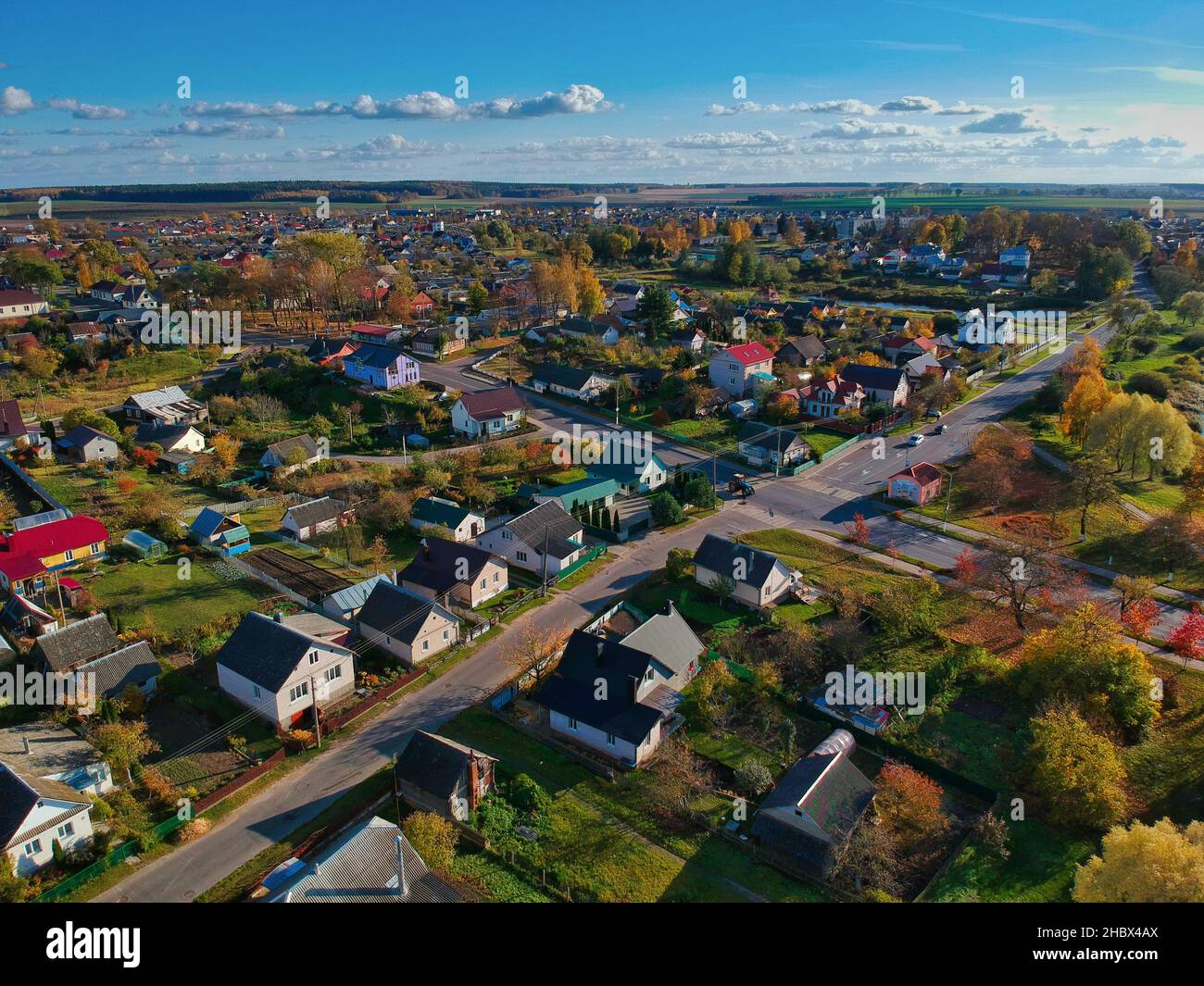 An aerial view of city landscape, green paths, rural houses on a sunny ...