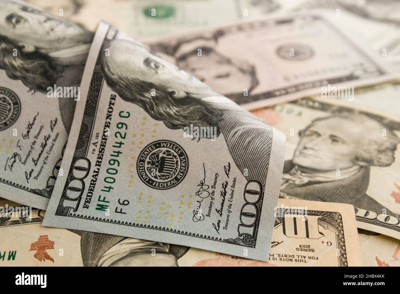 American Hundred Dollar Banknotes curved on other banknotes Stock Photo ...