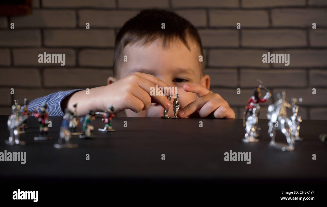Photo of four-year-old kid playing with tin soldiers Stock Photo - Alamy Photo of four-year-old kid playing with tin soldiers Stock Photo - Alamy