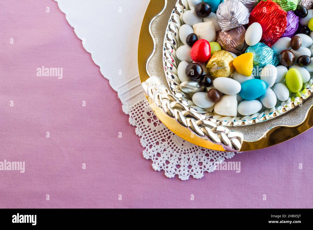 Mixed Colorful Candy and Chocolates in the shiny,metal tray on handmade ...