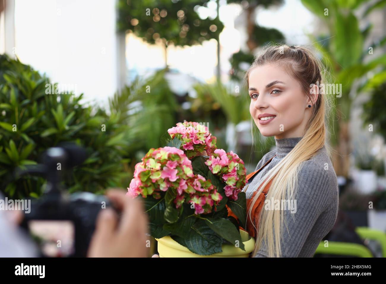 Beautiful blonde florist studio worker record promotion for botanical ...