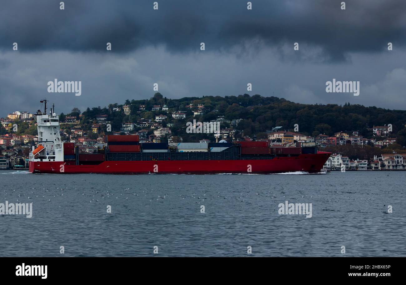 Red color,long cargo ship passes through the waters of istanbul.A ...