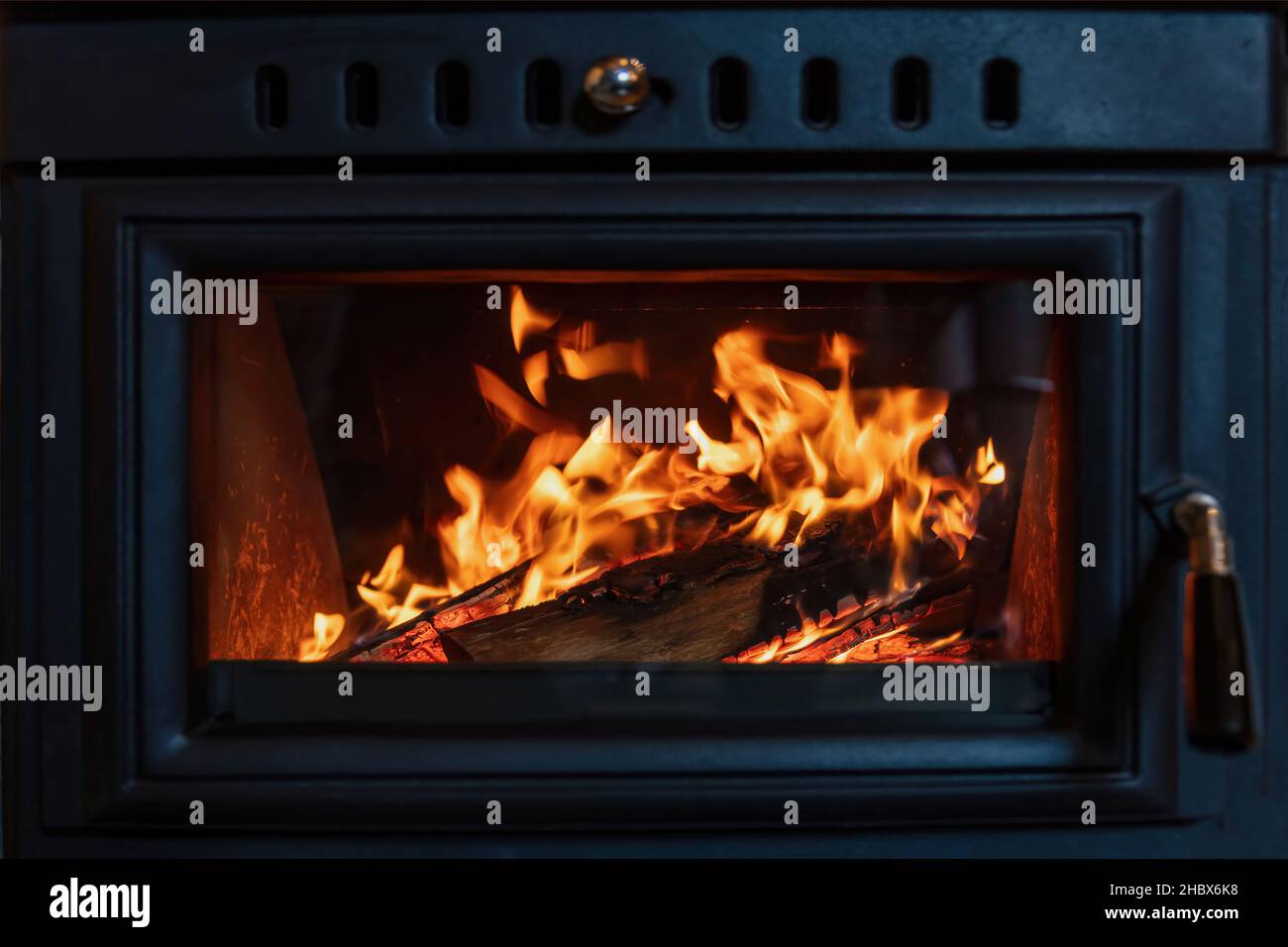 Burning fireplace firewood behind glass hi-res stock photography and ...