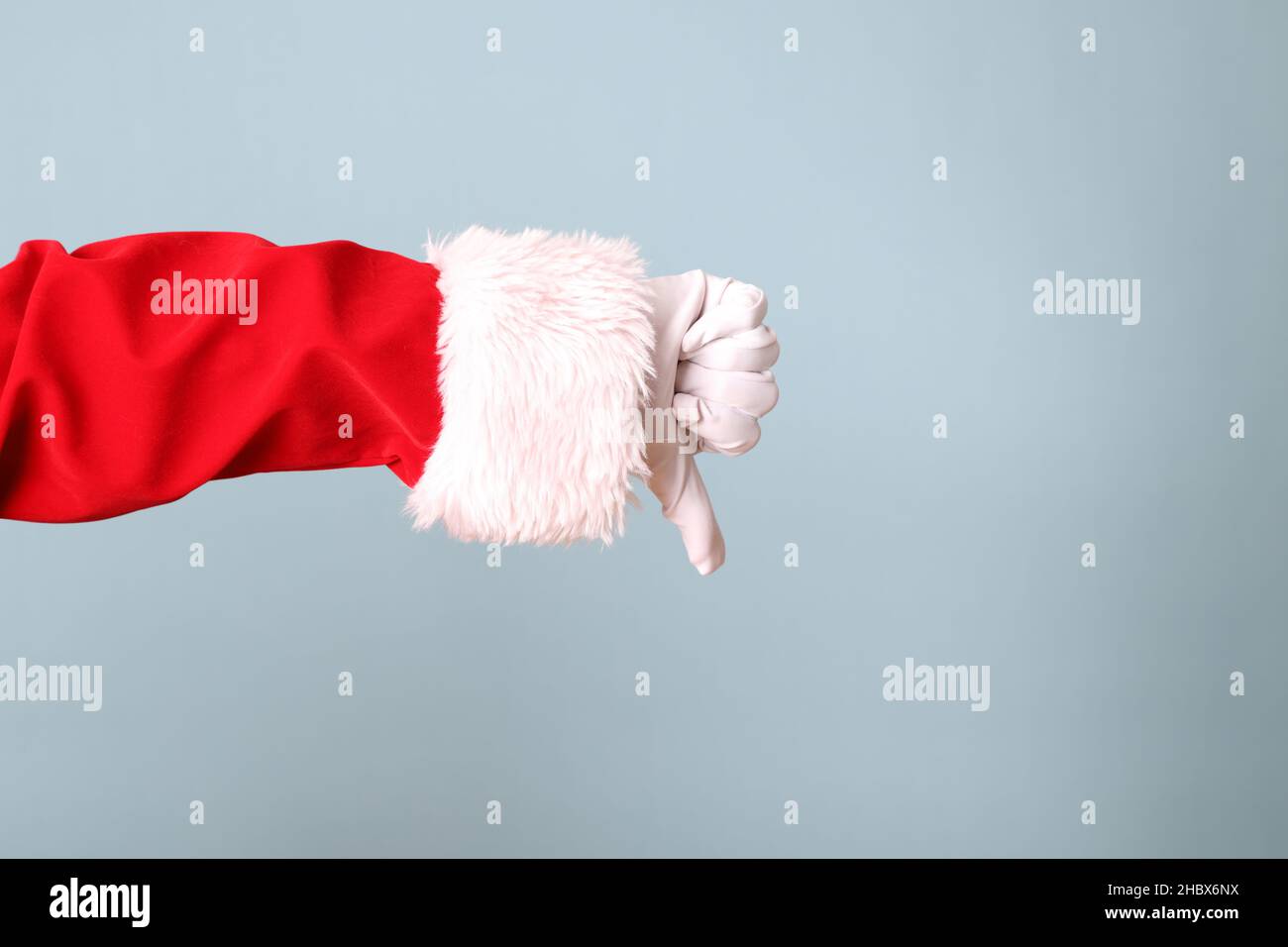 The Santa Claus hand showing on the blue background Stock Photo - Alamy