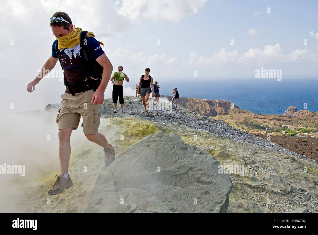 Hikers on the ridge of Volcano crater Stock Photo - Alamy