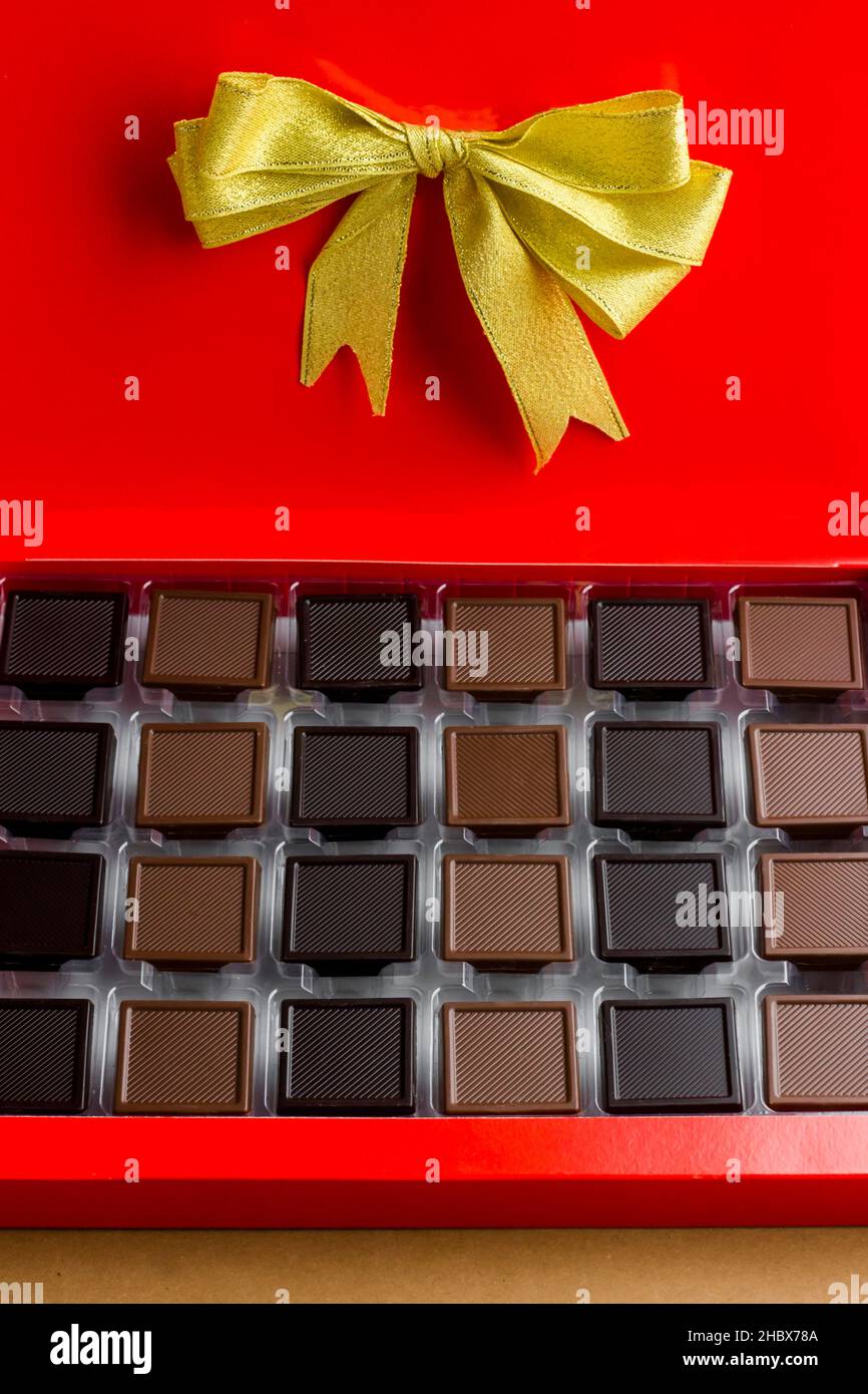 Luxury madlen chocolate in red color box with yellow color ribbon ...
