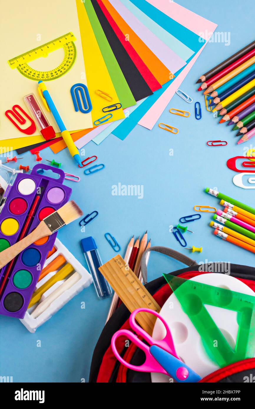 Colorful school supplies on the pastel blue color surface with blank ...