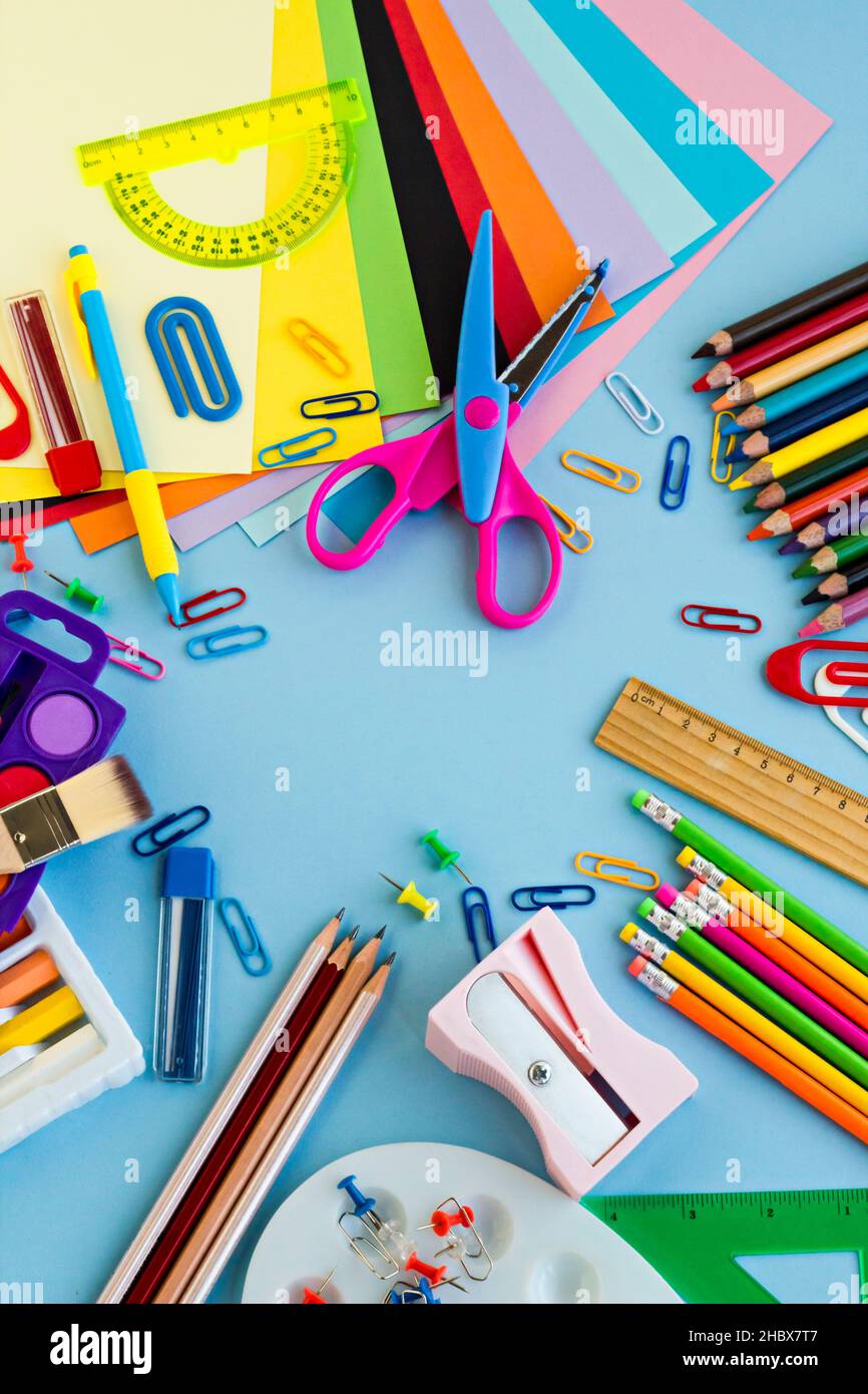Colorful school supplies on the pastel blue color surface with blank ...