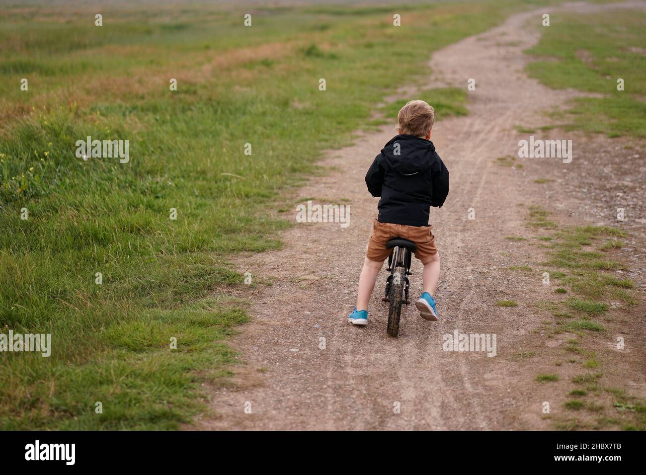 A young boy enjoys a cycle ride Stock Photo - Alamy