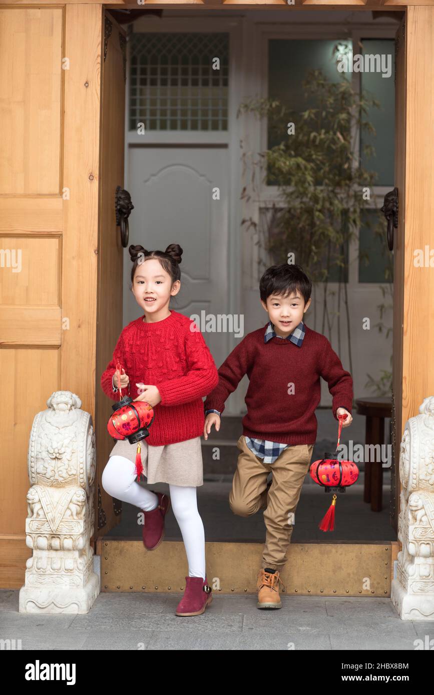 Brother and sister playing with lanterns Stock Photo - Alamy