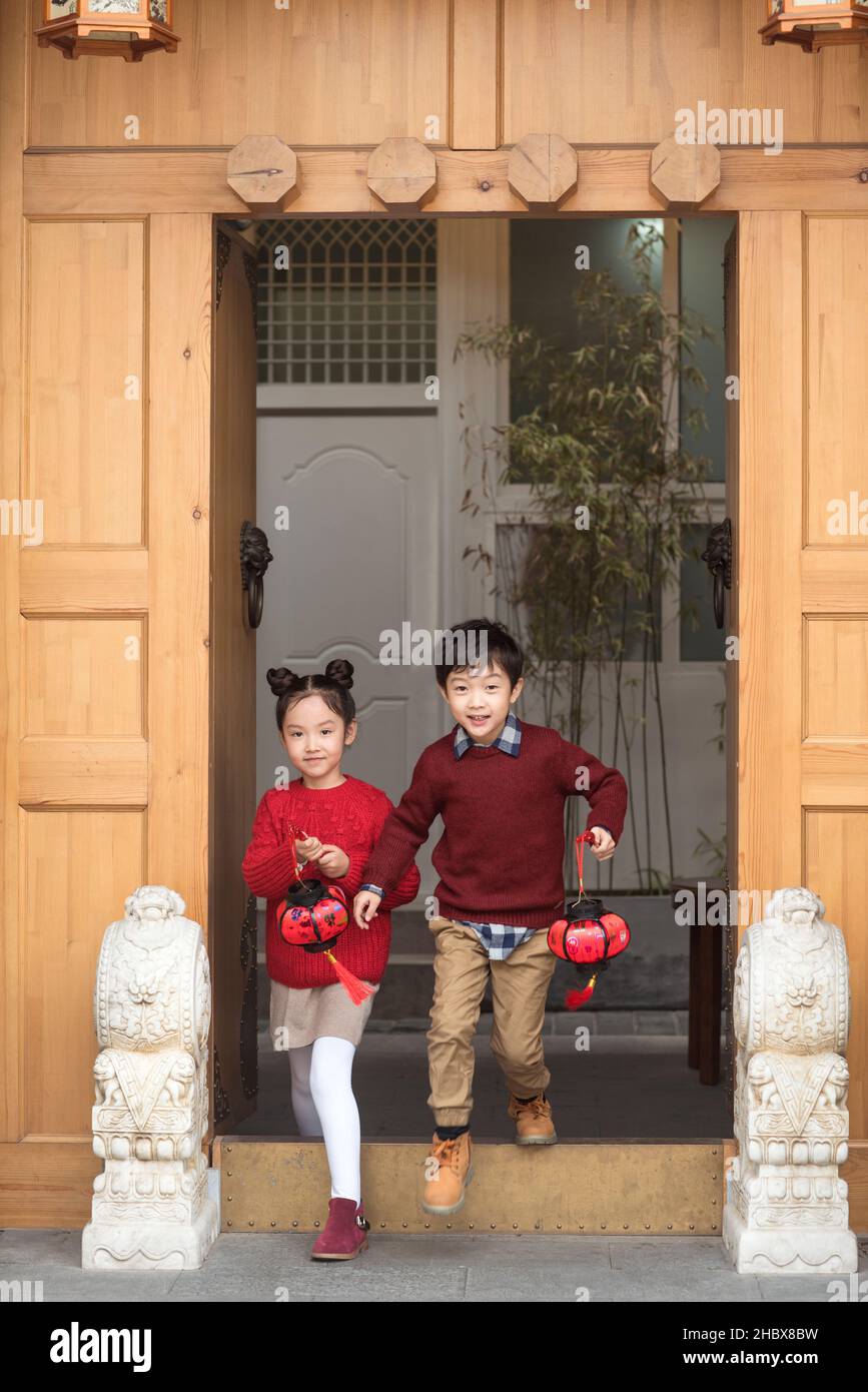 Brother and sister playing with lanterns Stock Photo - Alamy