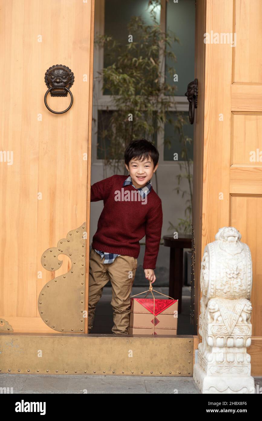 Little boy holding gift boxes Stock Photo - Alamy