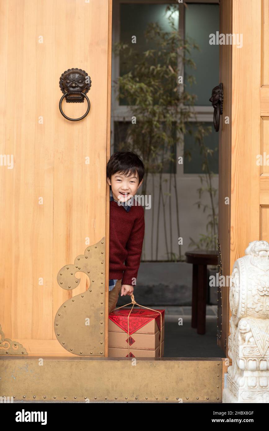 Little boy holding gift boxes Stock Photo - Alamy