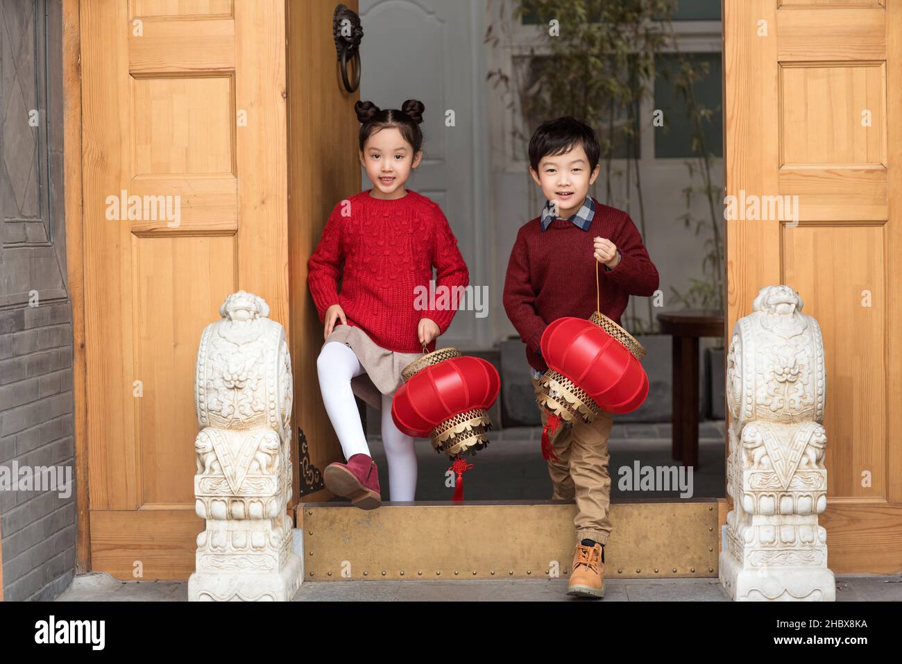 Brother and sister playing with lanterns Stock Photo - Alamy