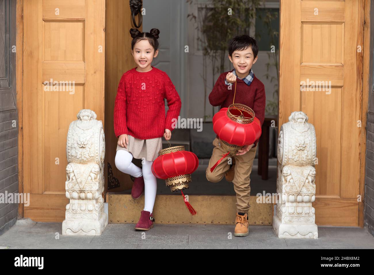 Brother and sister playing with lanterns Stock Photo - Alamy