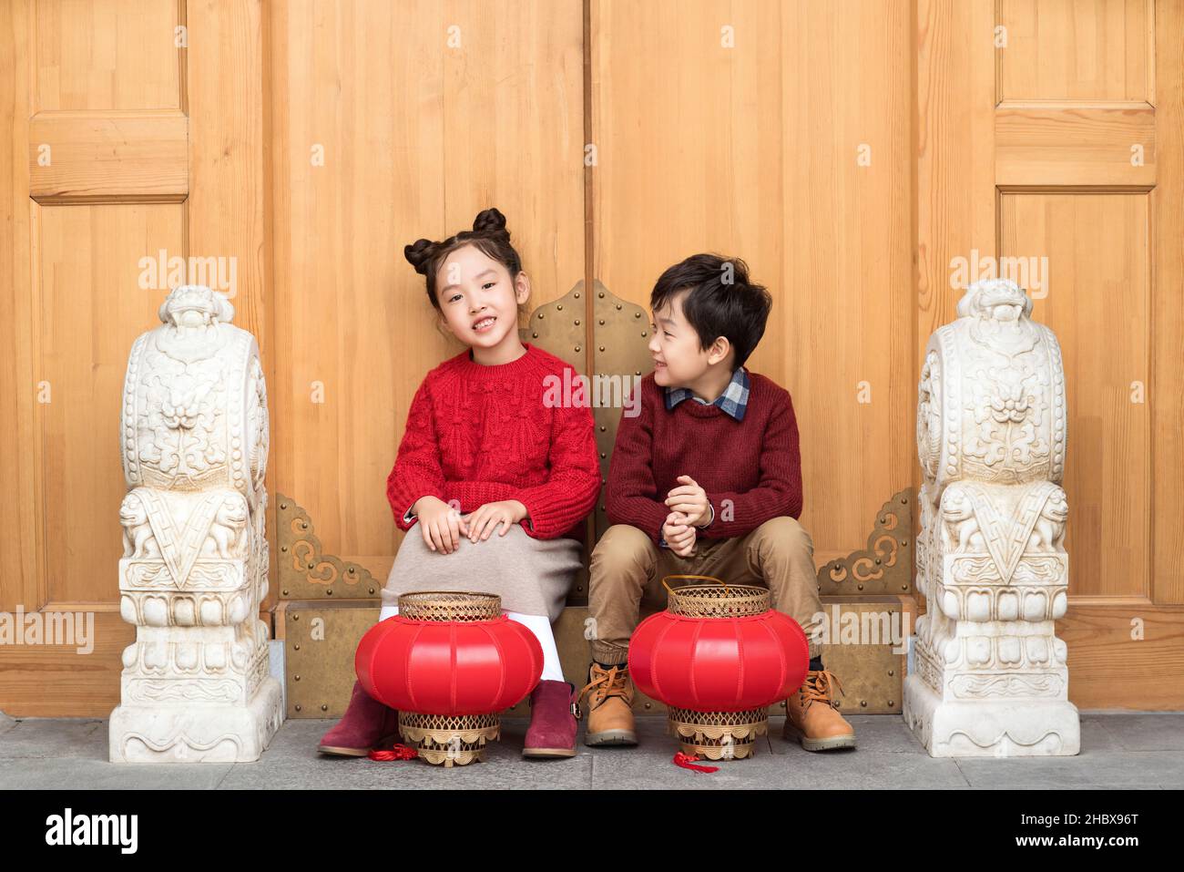 Brother and sister sitting at the door Stock Photo - Alamy