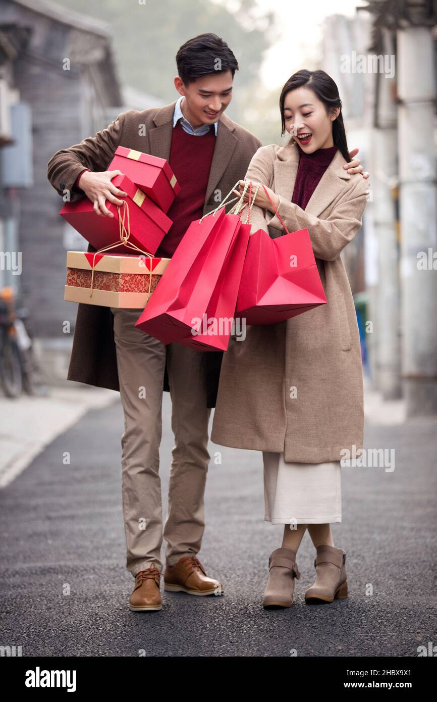Happy young lovers carrying gifts Stock Photo - Alamy