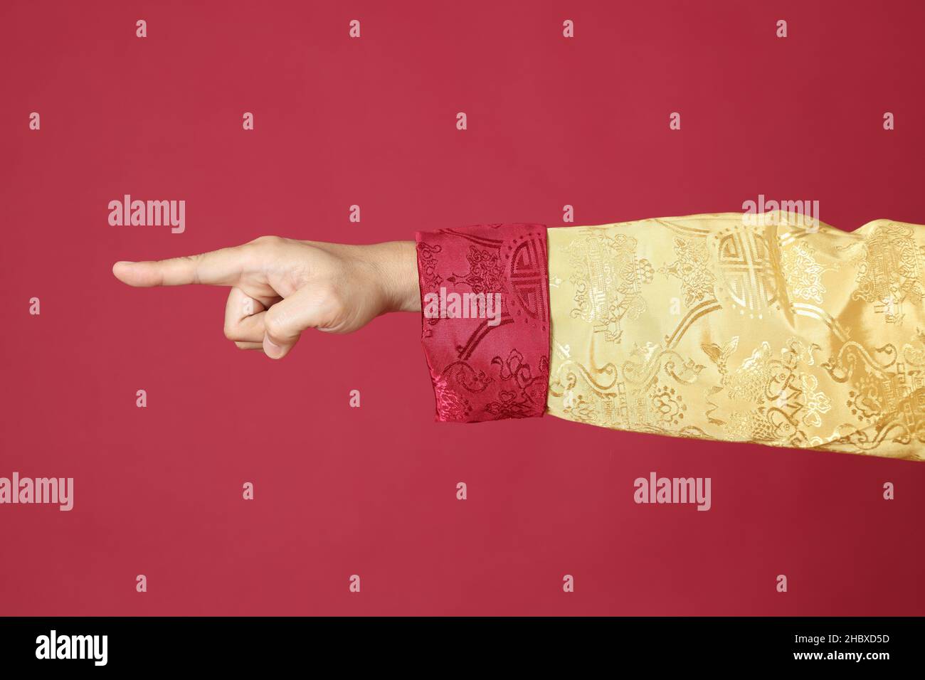 The Chinese man hand with tradion dressed on the red background Stock ...