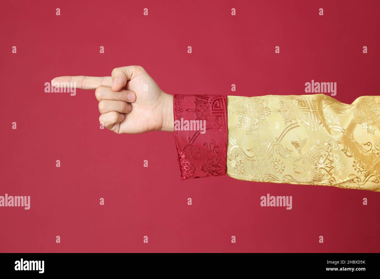 The Chinese man hand with tradion dressed on the red background Stock ...