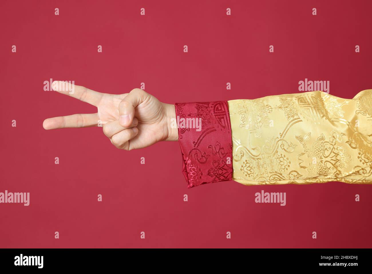 The Chinese man hand with tradion dressed on the red background Stock ...