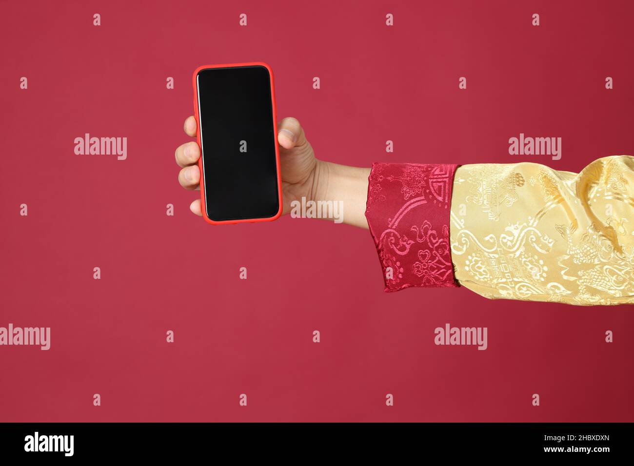 The Chinese man hand with tradion dressed on the red background Stock ...