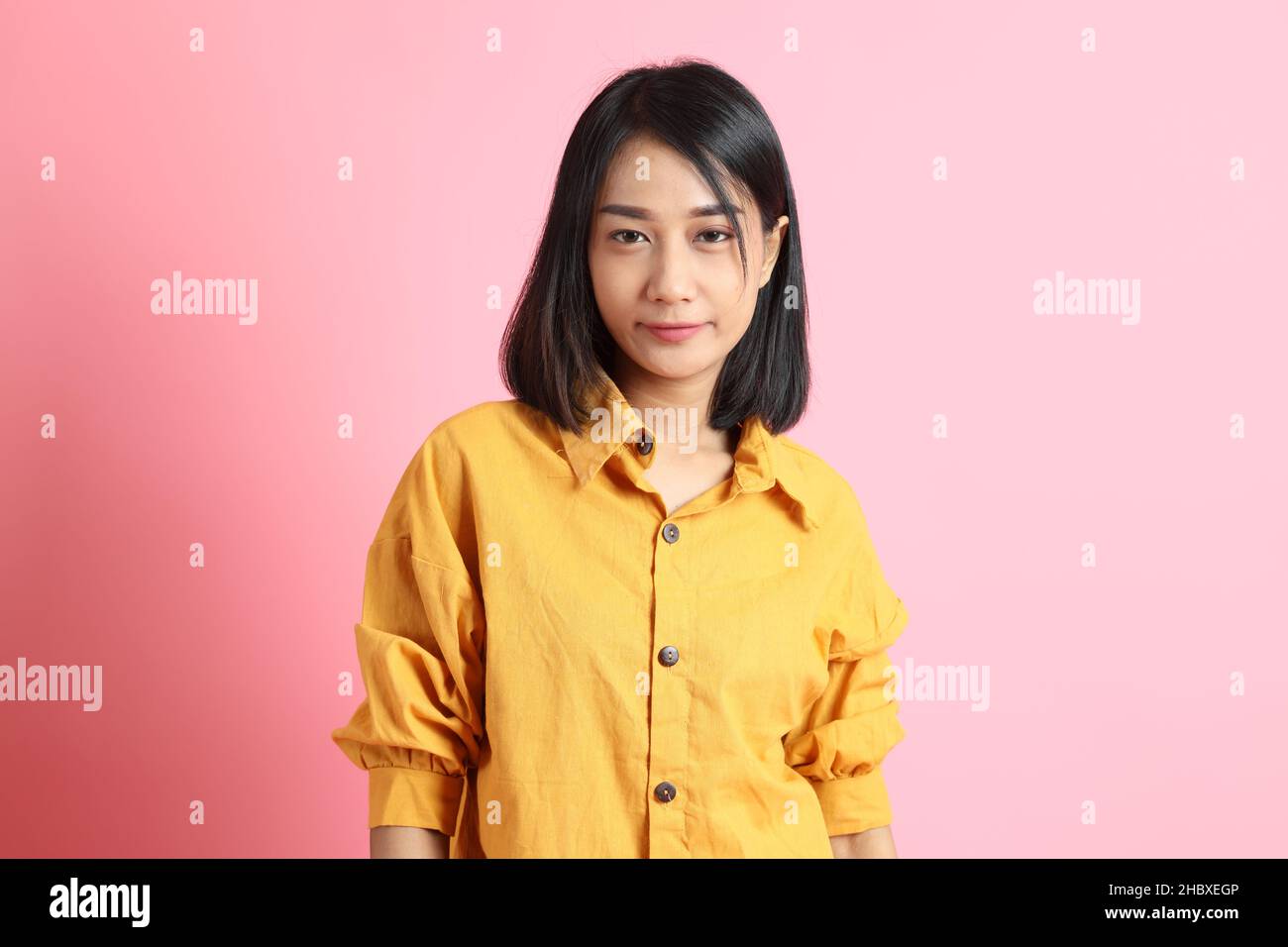 The mixed race woman standing on the paink background Stock Photo - Alamy